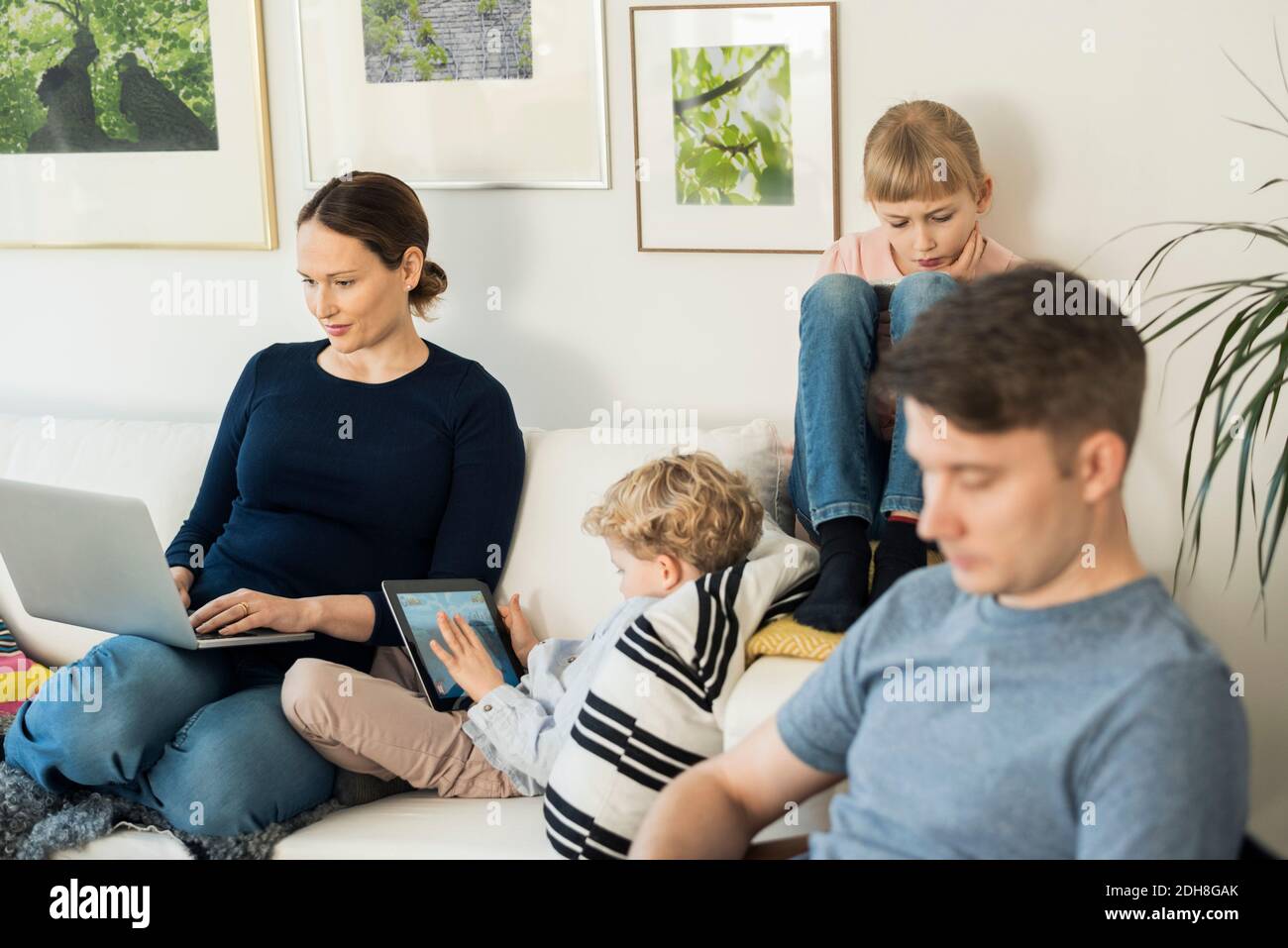 Family using technologies at home Stock Photo - Alamy