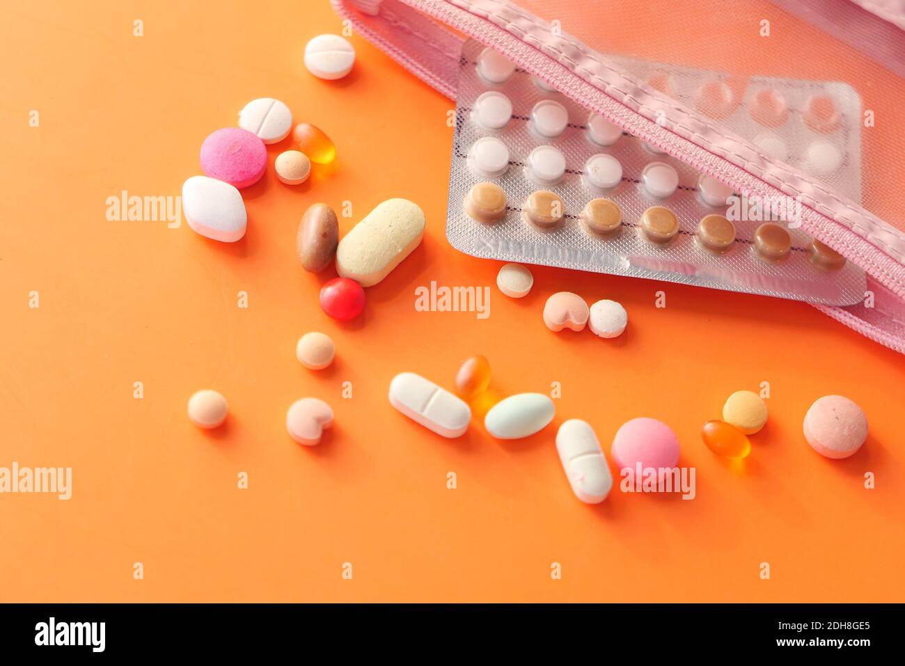 birth control pills on orange background, close up Stock Photo - Alamy