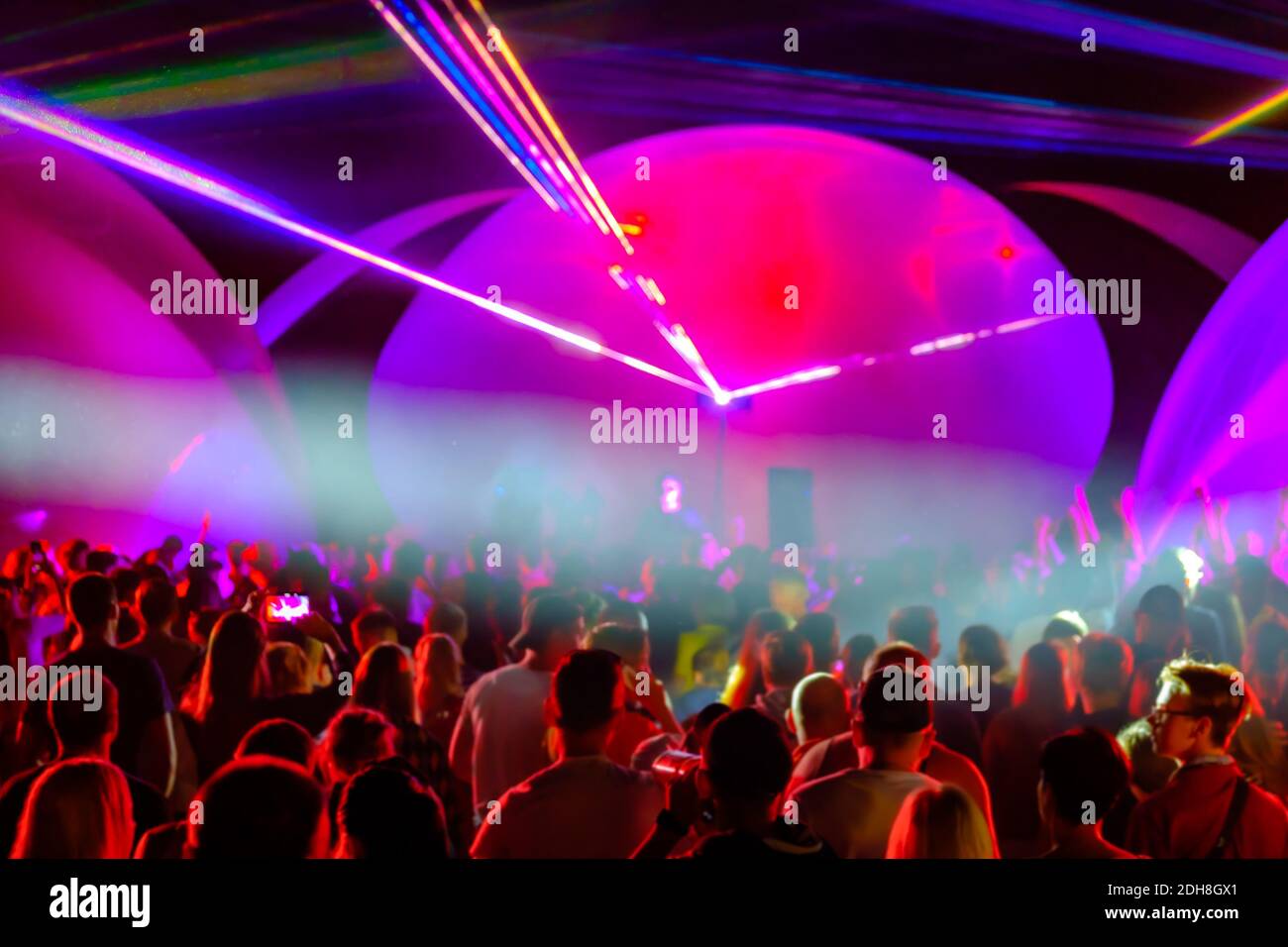 Crowd and DJs dancing during party Stock Photo - Alamy