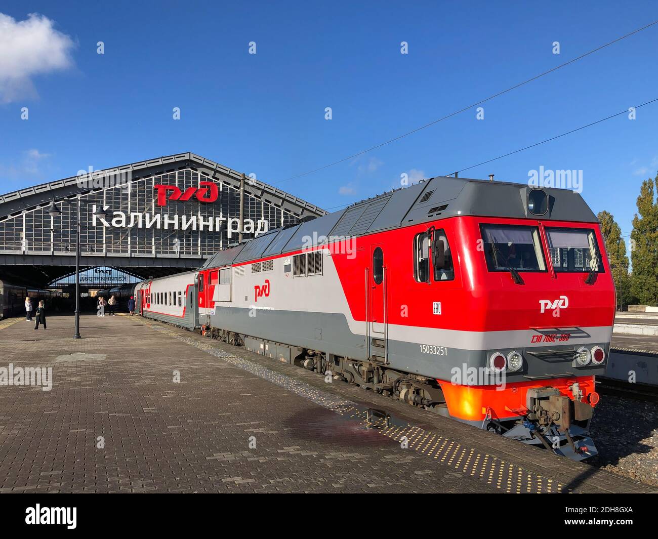 Modern train on platform of railway station Stock Photo - Alamy