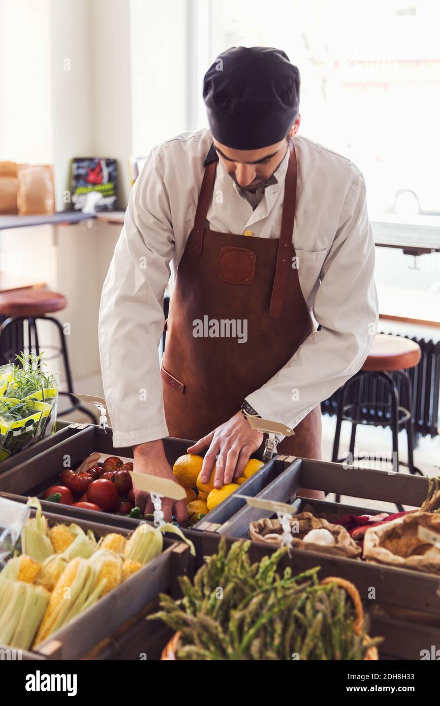 Male owner arranging vegetables at grocery store Stock Photo - Alamy