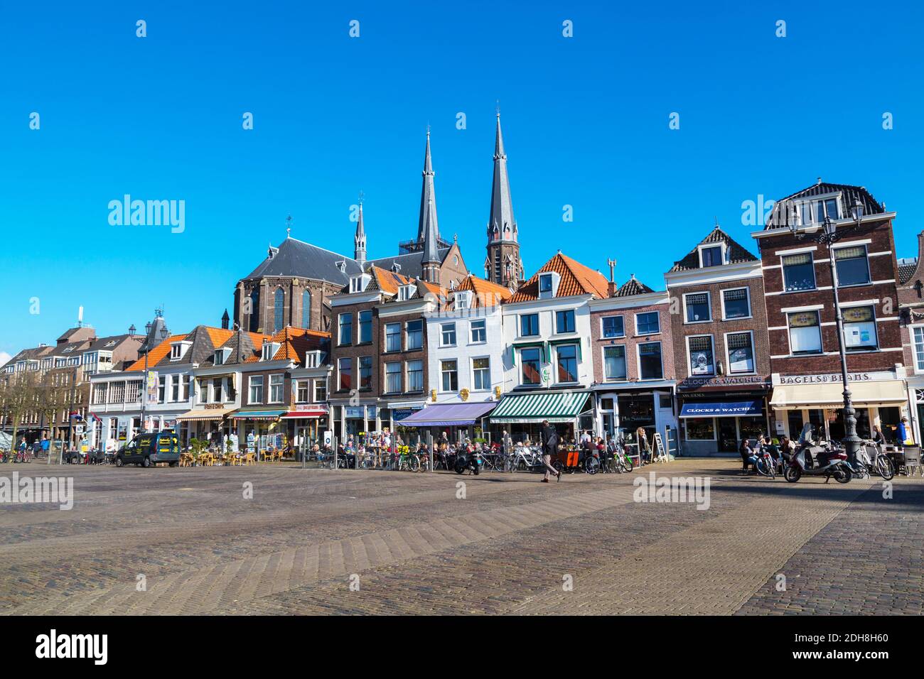 Colorful street view with houses and people in Delft, Holland Stock ...