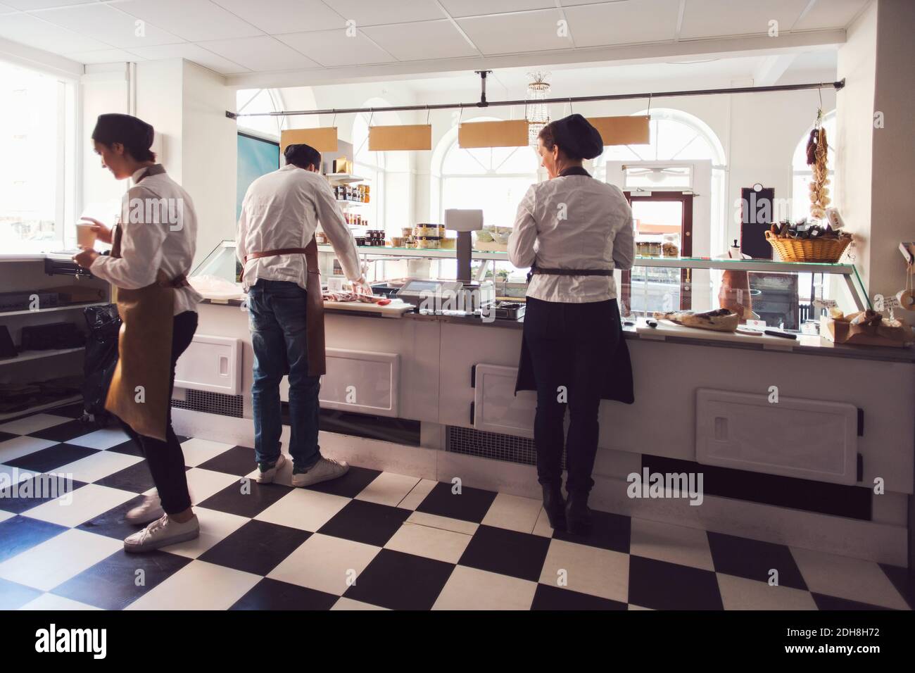 Owners working together in grocery store Stock Photo - Alamy
