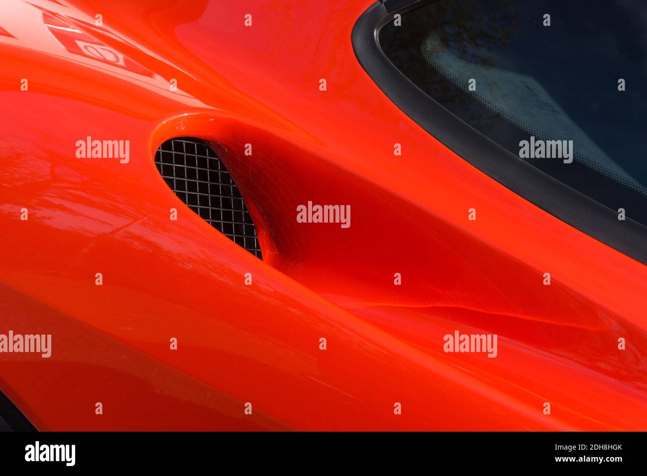 Close up detail of the side air intake duct on a red rosso corsa ...