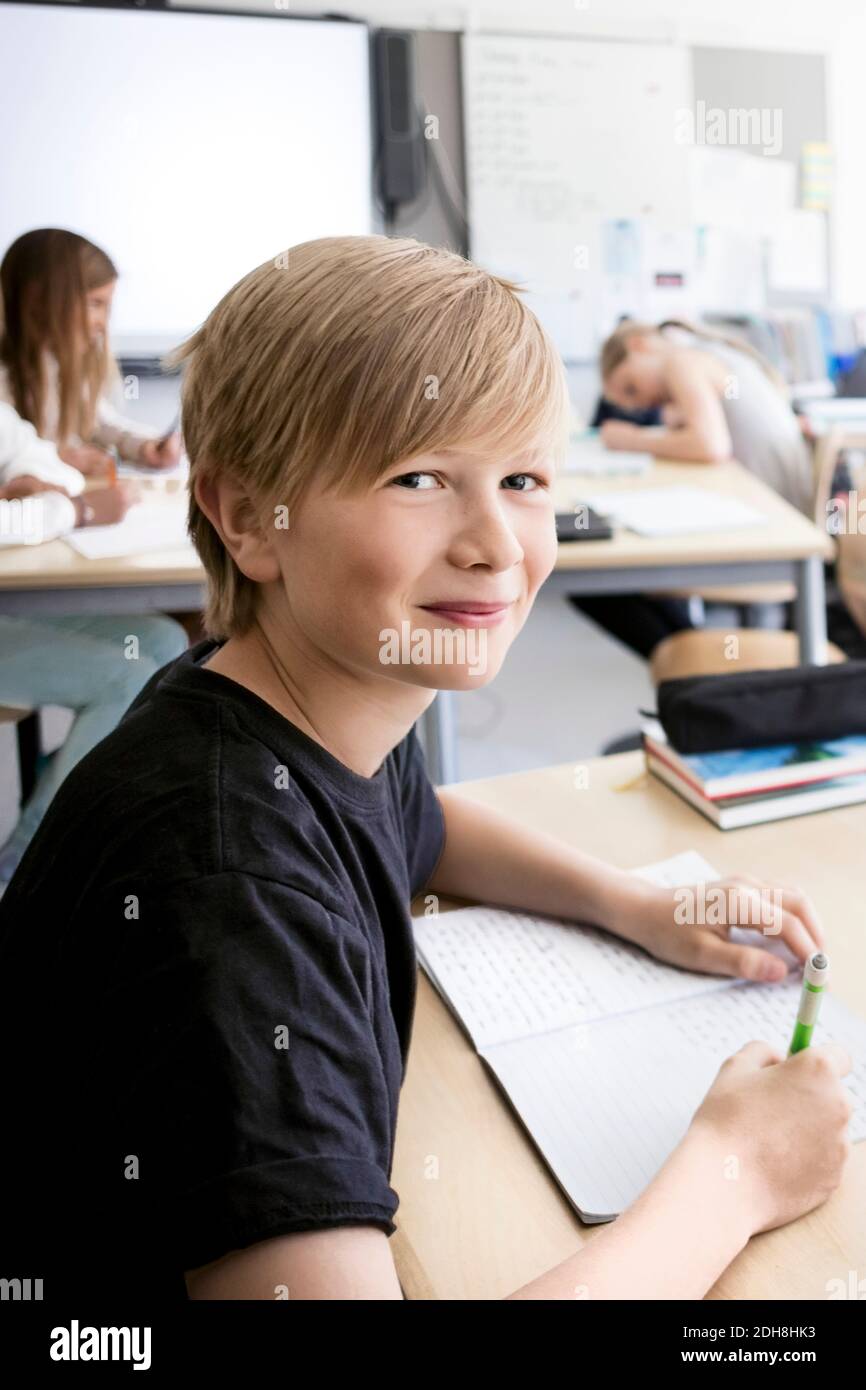 Blond schoolboy in classroom hi-res stock photography and images - Alamy