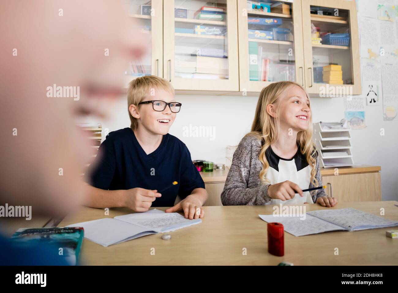 Happy students sitting in classroom Stock Photo - Alamy