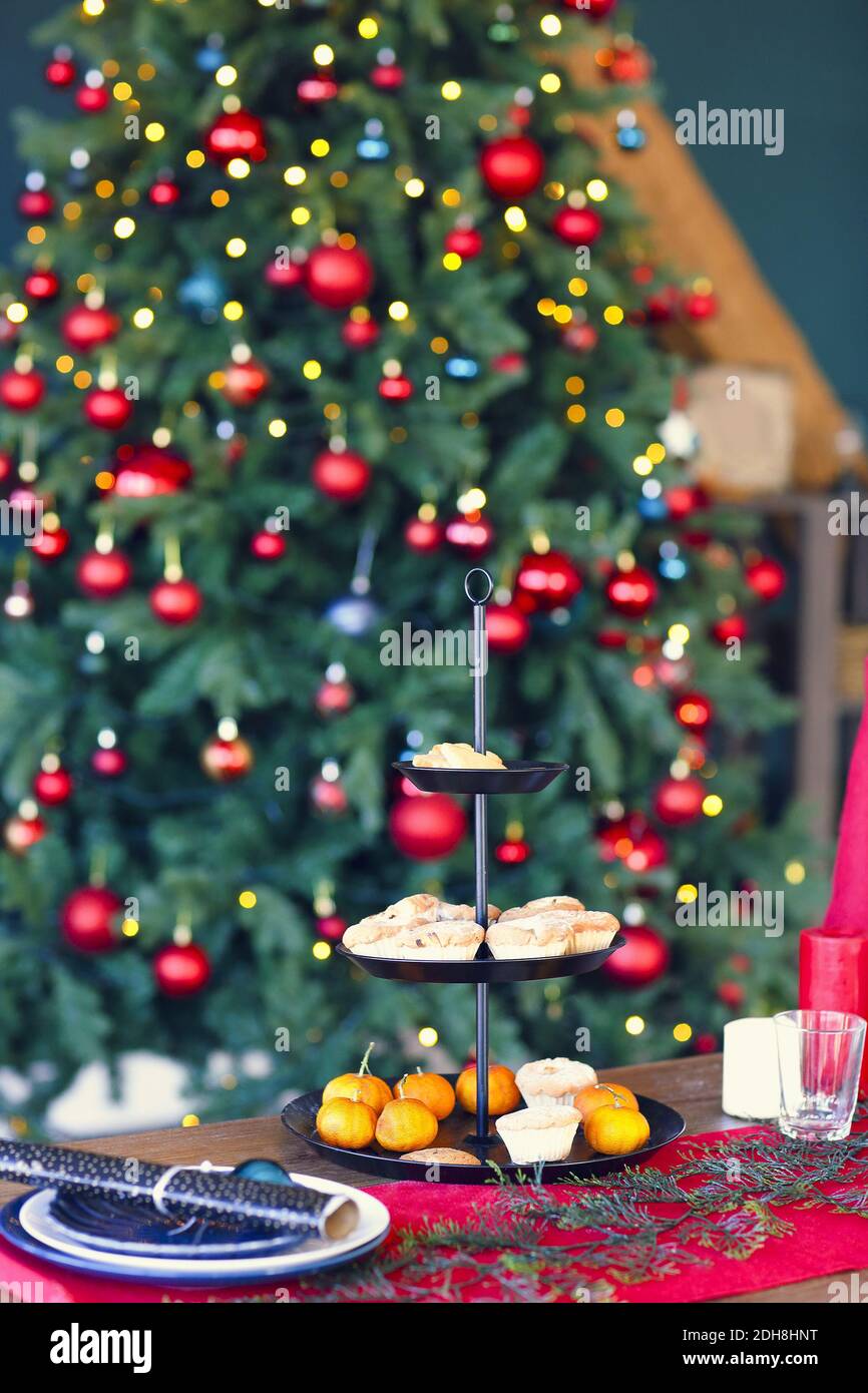 Christmas table and decorated tree Stock Photo - Alamy