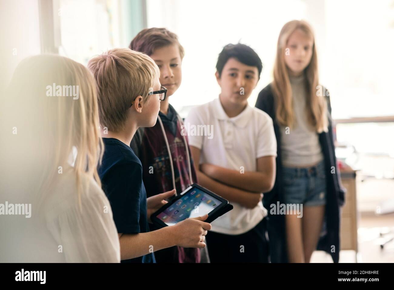 Happy high school students giving presentation with digital tablet in ...