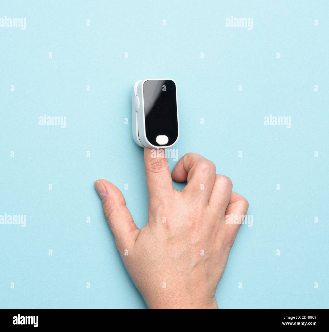 checking blood oxygen level with a portable oximeter, blue background ...