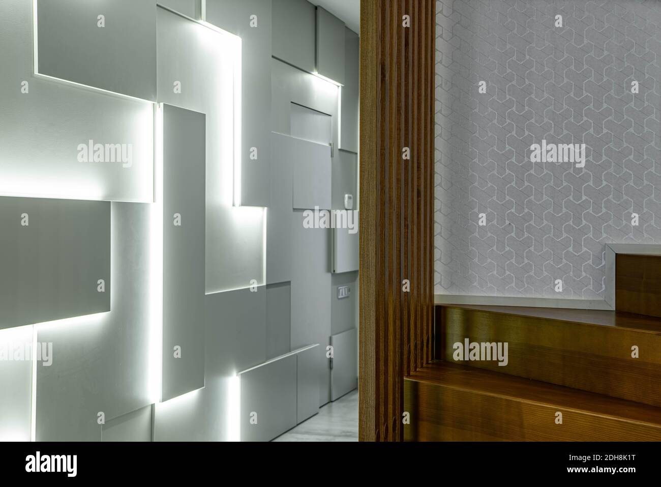 Modern hi-tech geometric design of wall with lamps in luxury interior ...