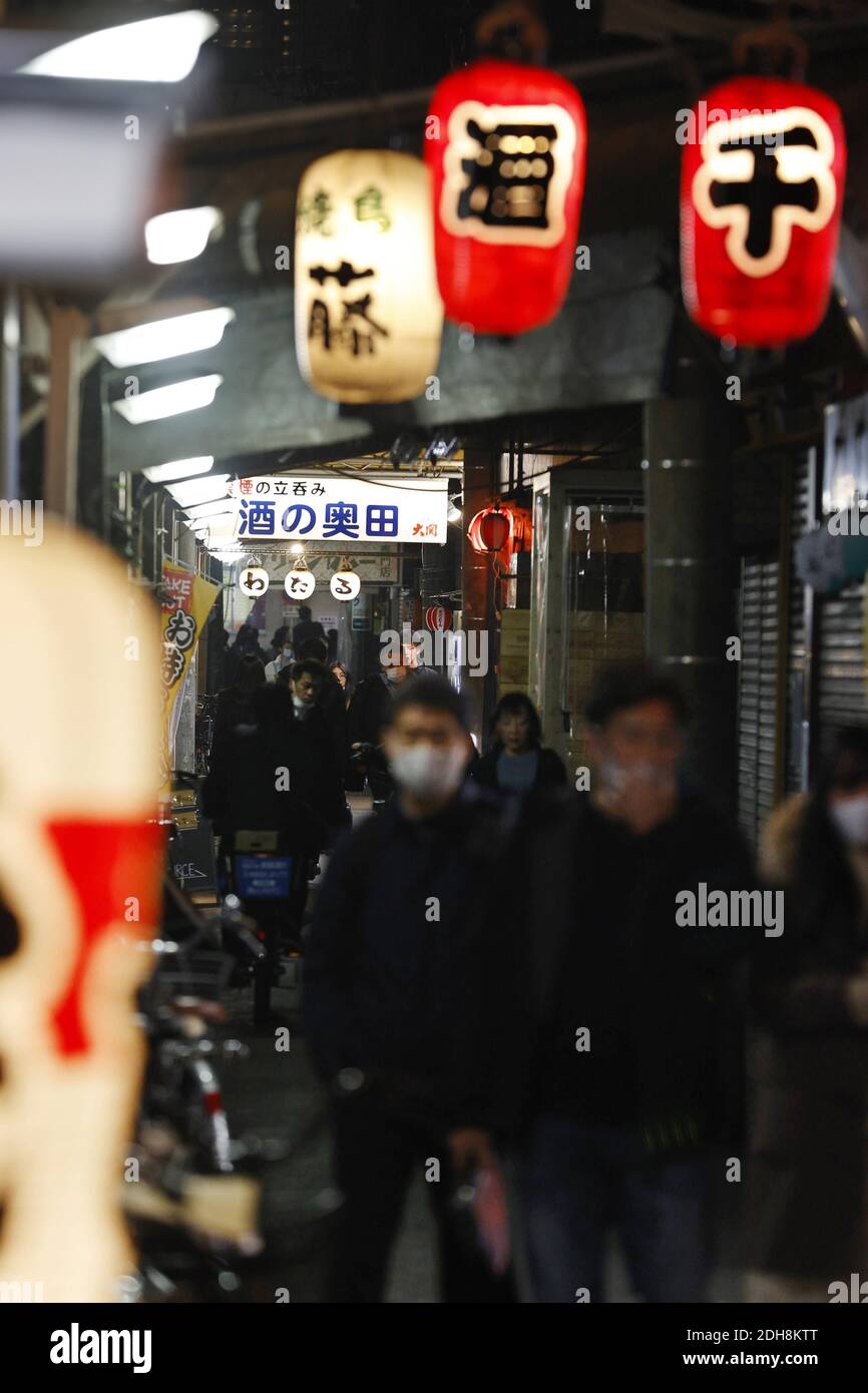 People wearing face masks walk in Osaka on Dec. 10, 2020. Osaka ...