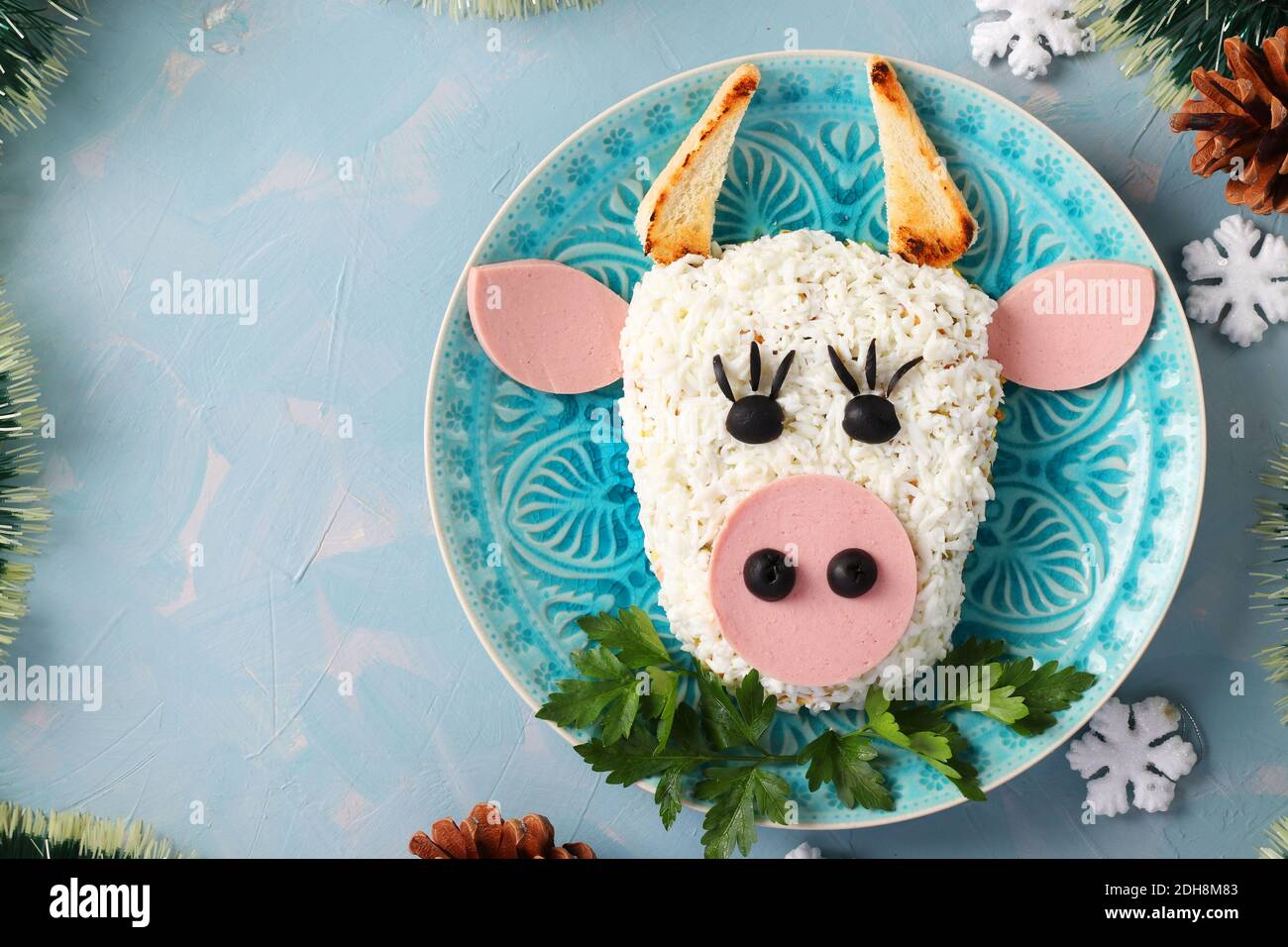 Festive Bull-shaped salad for 2021 on light blue background, Symbolic ...