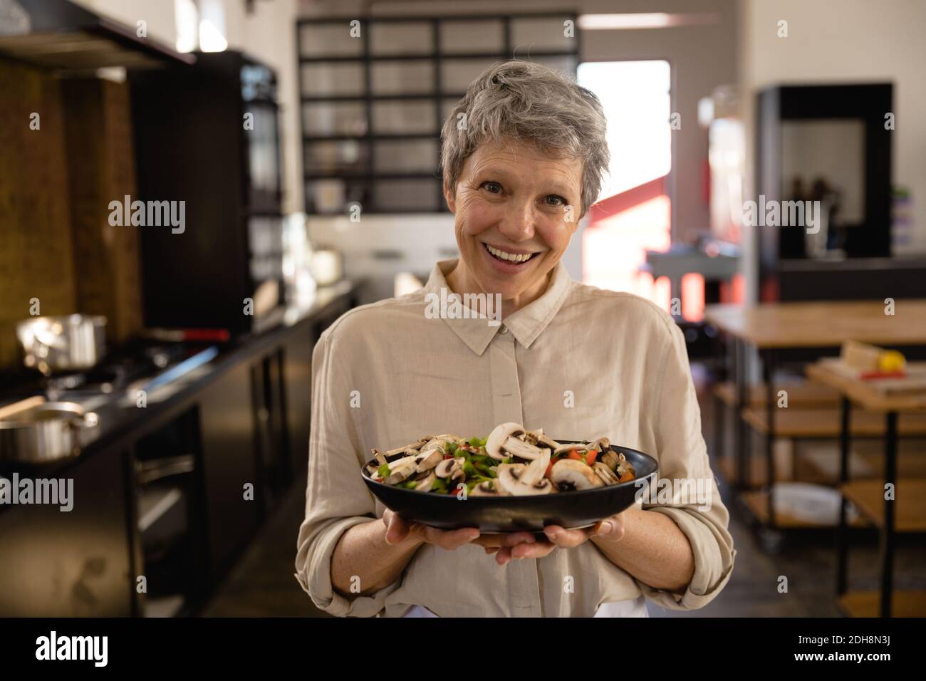 Female chef showing dish hi-res stock photography and images - Alamy