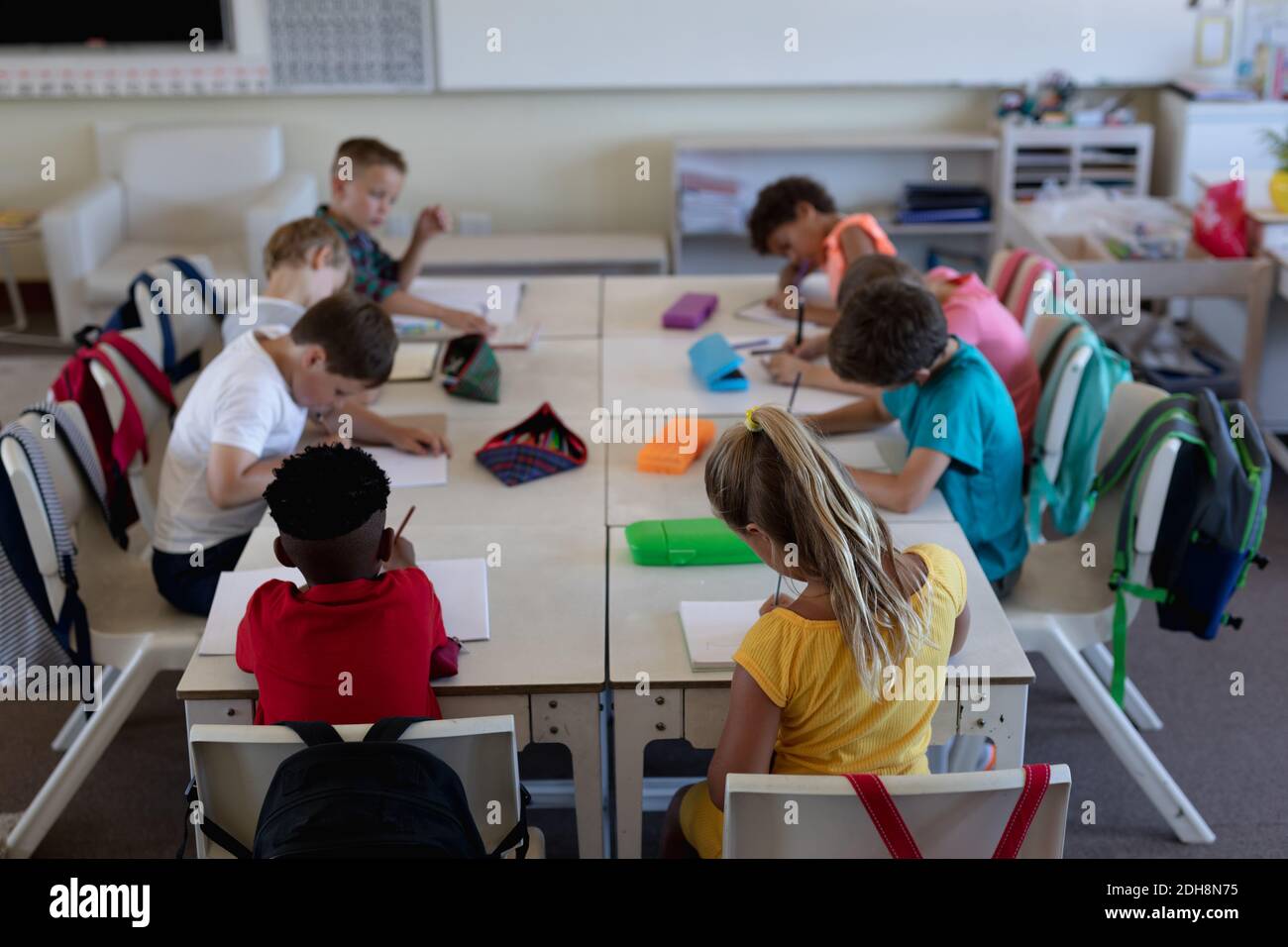 Group of schoolchildren working in an elementary school classroom Stock ...