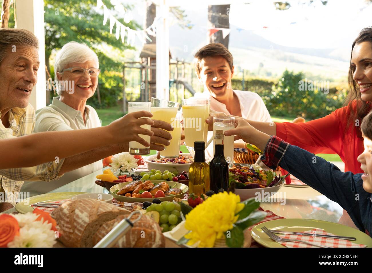 Family eating outside together in summer Stock Photo - Alamy