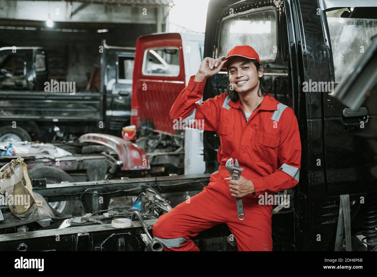 portrait of mechanic carry tools in his hand in his workshop Stock ...