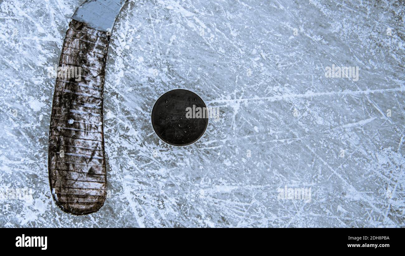 close-up stick and puck on the ice background Stock Photo - Alamy