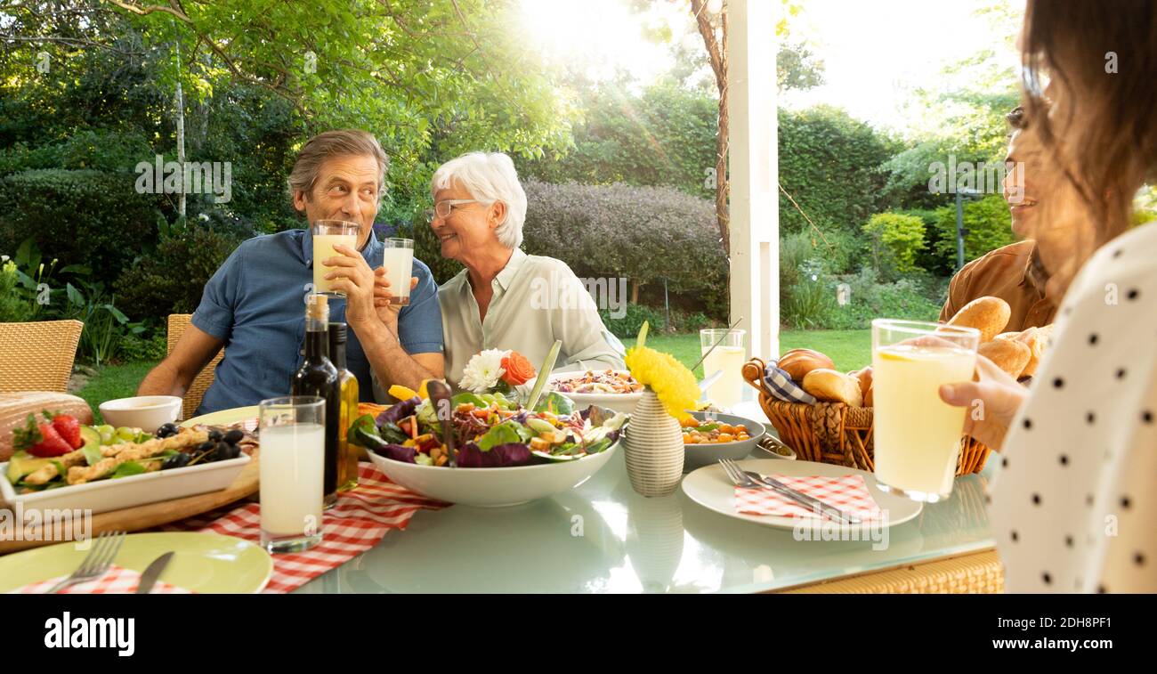 Family eating outside together in summer Stock Photo - Alamy