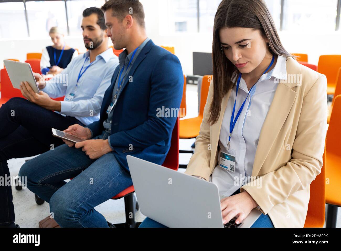 Businesswoman using laptop in a office Stock Photo - Alamy