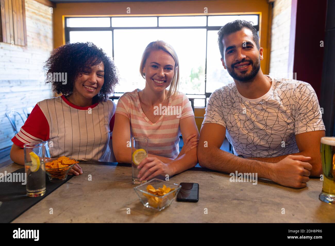 Front view friends looking at the camera Stock Photo - Alamy