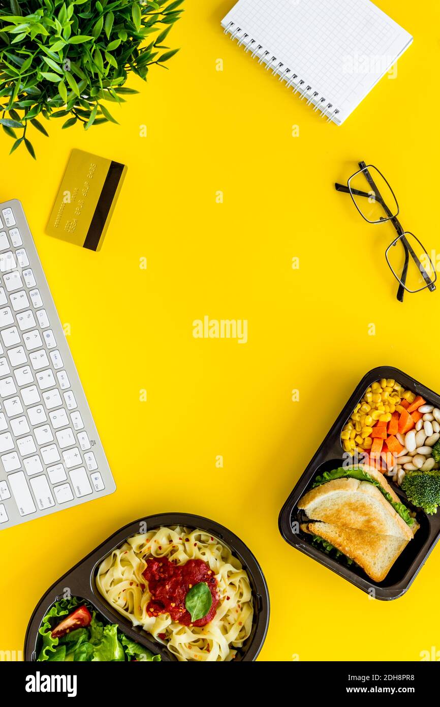 Lunch at workplace. Delivery boxes with meal, top view Stock Photo - Alamy