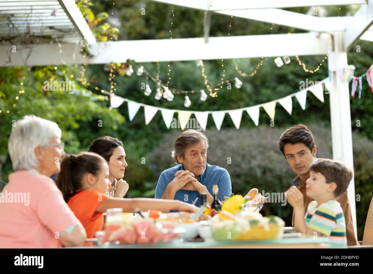 Multi generation family enjoying dinner outside hi-res stock ...