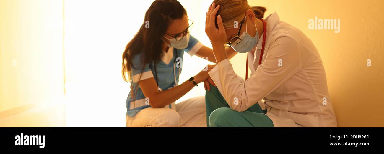 Doctor squat in hallway of hospital and cry Stock Photo - Alamy