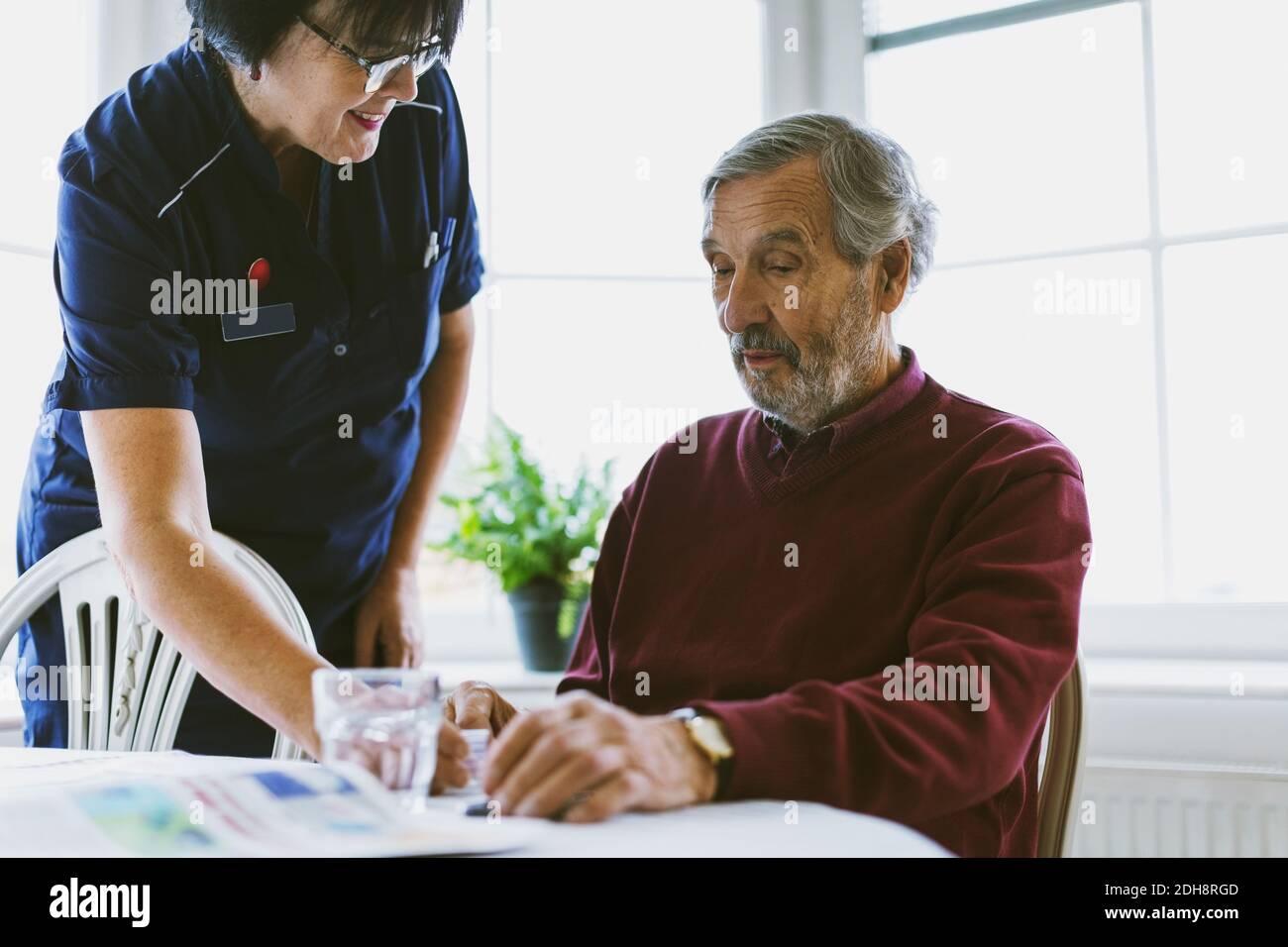 Nurse giving medicine hi-res stock photography and images - Alamy