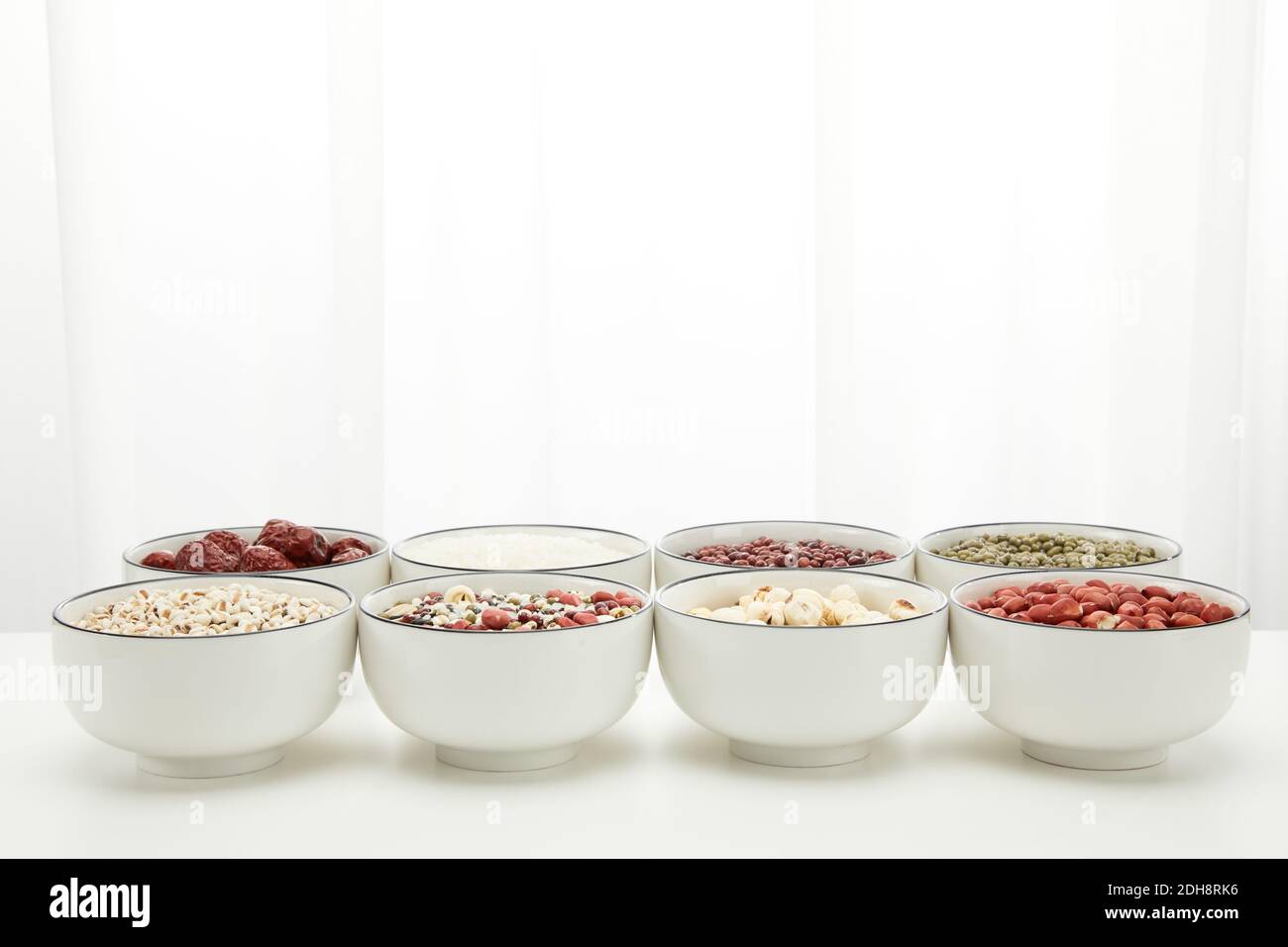 A top view closeup of four bowls filled with different kinds of nuts on ...