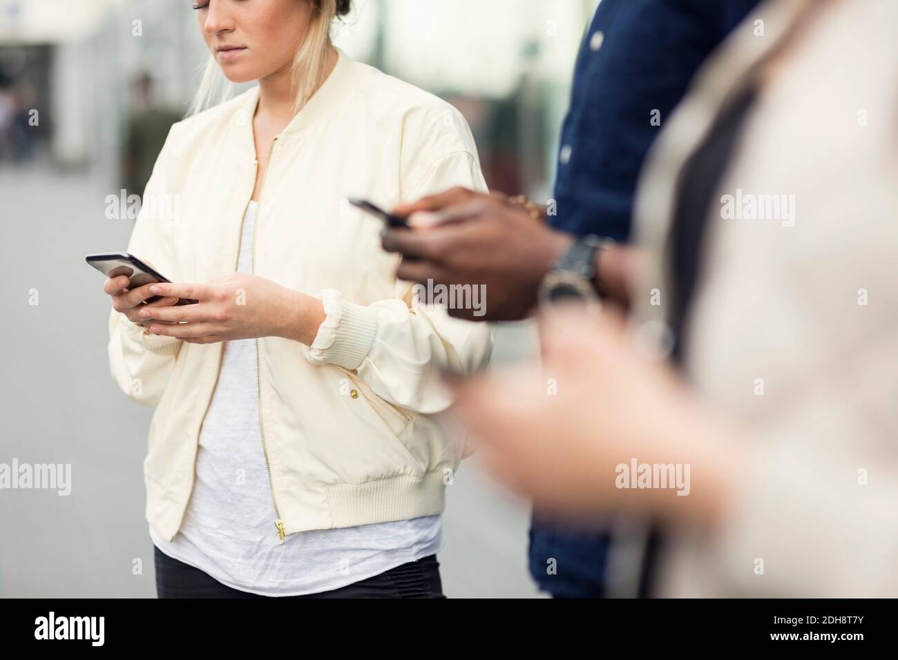 Young people using phones hi-res stock photography and images - Alamy
