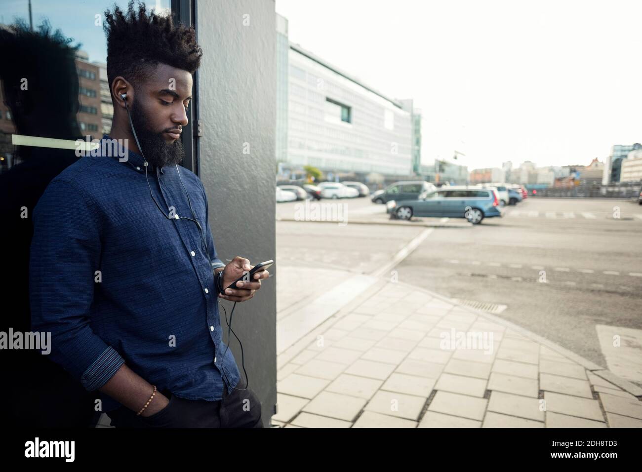 Standing communication listening hands in pockets hi-res stock ...