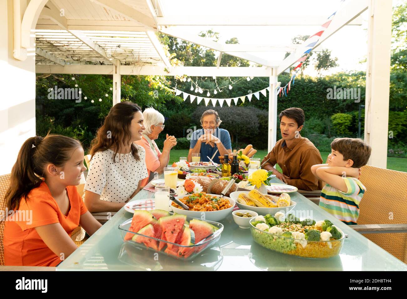Multi generation family enjoying dinner outside hi-res stock ...