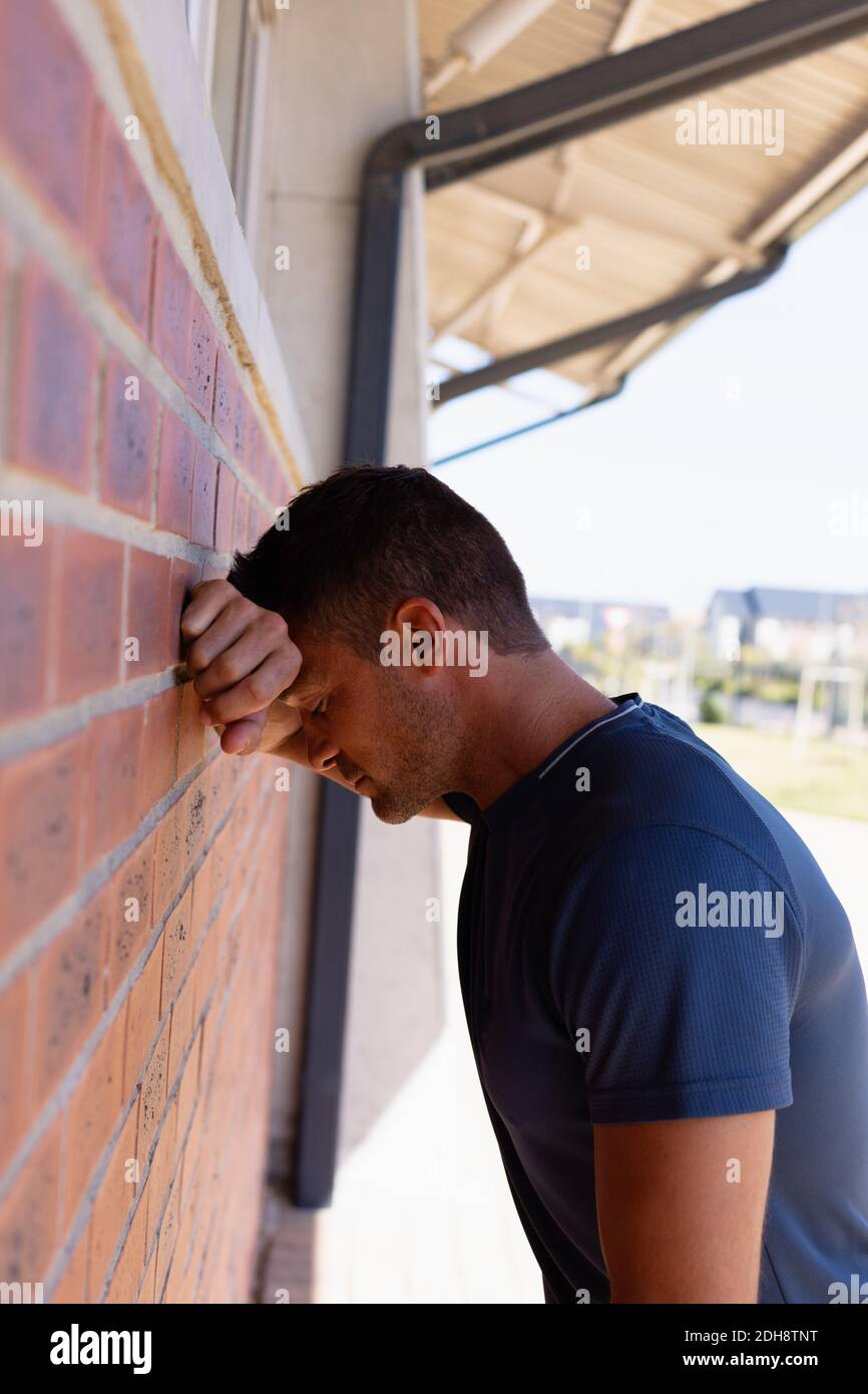 Man leaning on the wall Stock Photo - Alamy