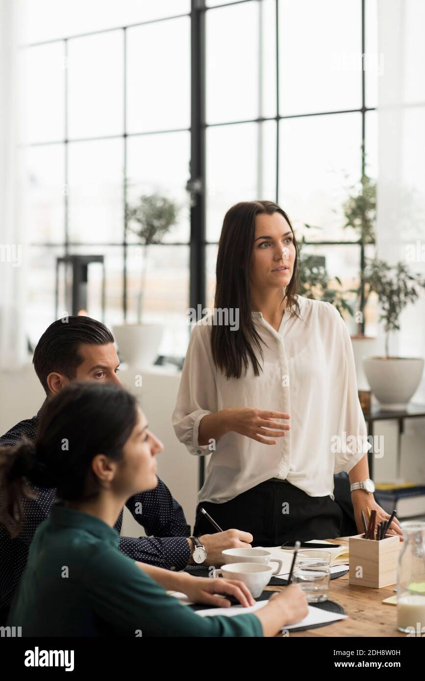 Concentrated business people in meeting at office Stock Photo - Alamy