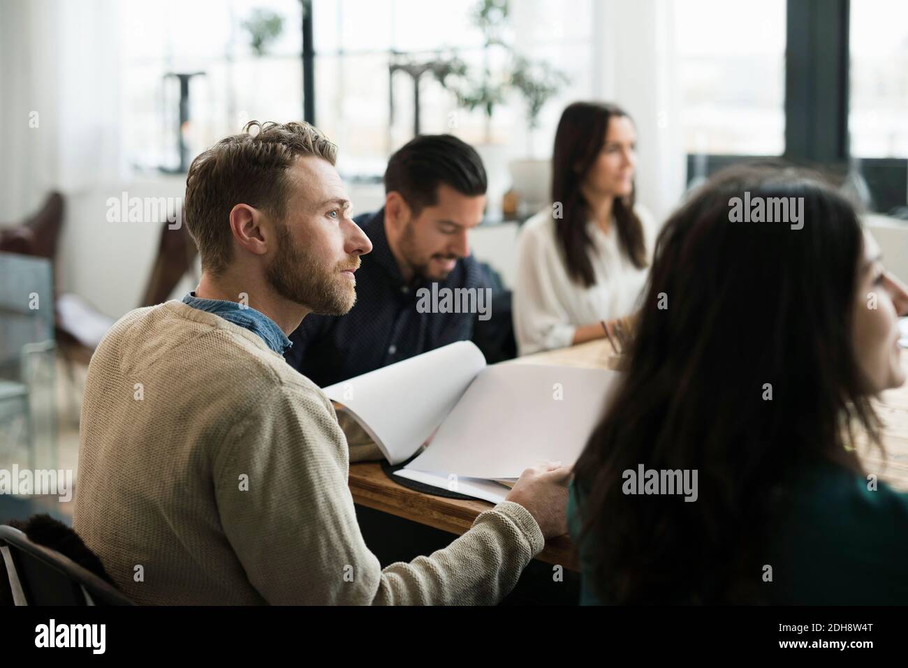 Business people listening in meeting hi-res stock photography and ...