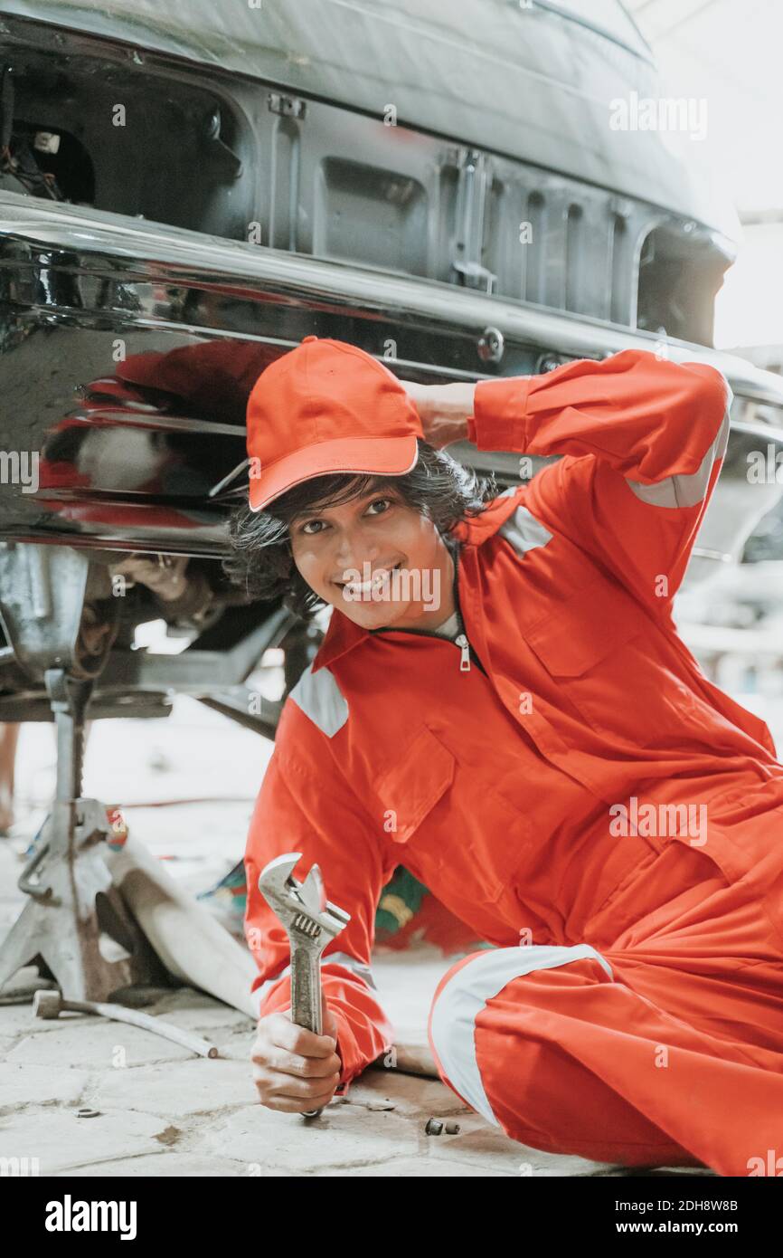 portrait of young asian man repairing a broken car engine part Stock ...