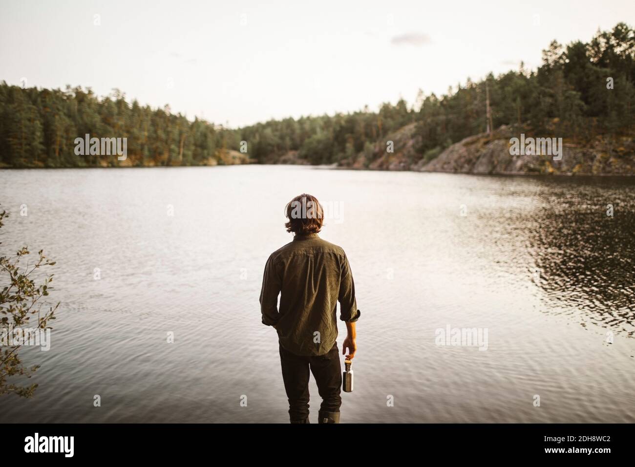Man standing by lake hi-res stock photography and images - Alamy