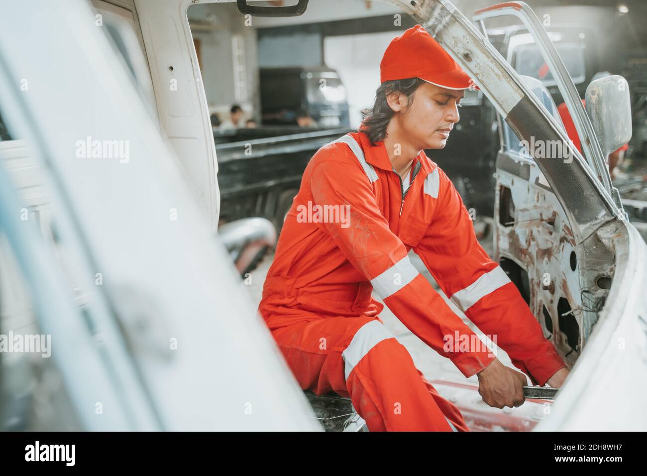 portrait of young asian man repairing a broken car engine part Stock ...