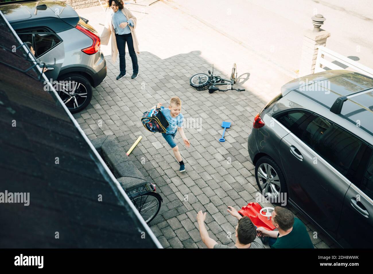 High angle view of son running towards father during weekend Stock ...