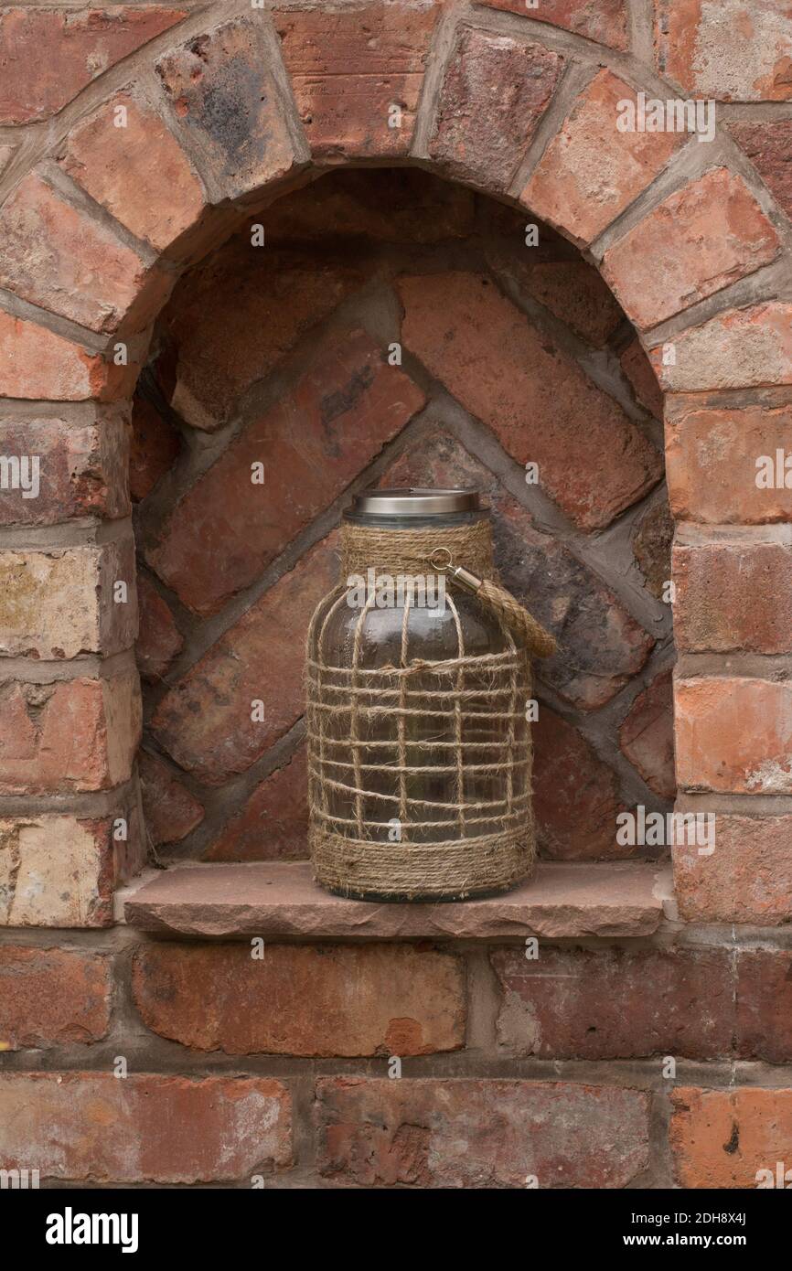 Brick arch feature in garden wall with traditional-style solar powered ...