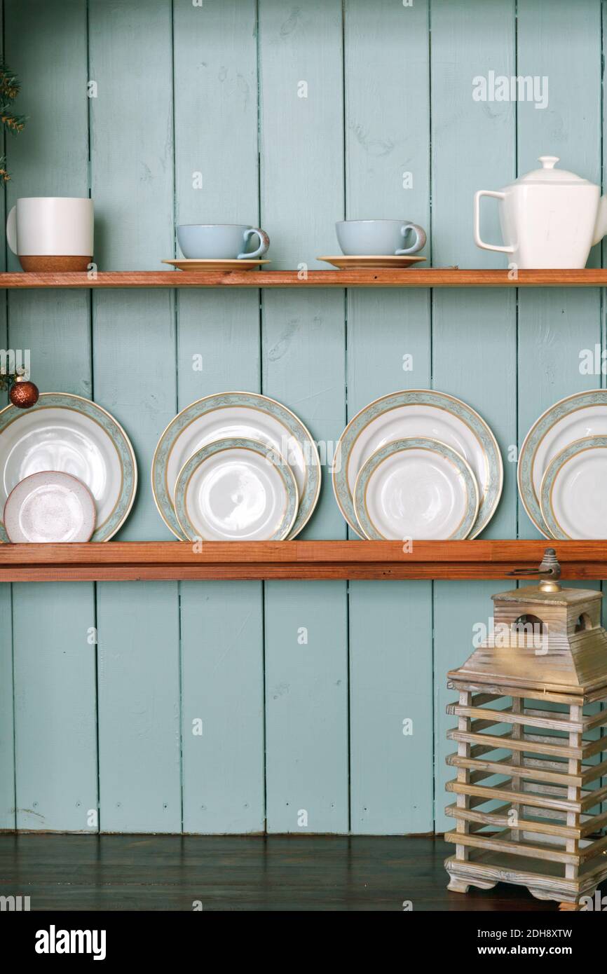 Rustic wooden shelves with ceramic utensils, plates and tea set Stock ...