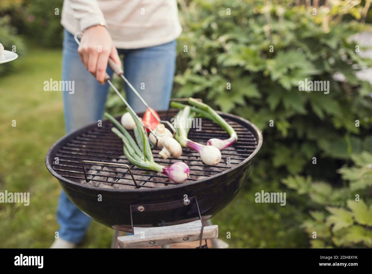 Teenage girl standing barbeque hi-res stock photography and images - Alamy