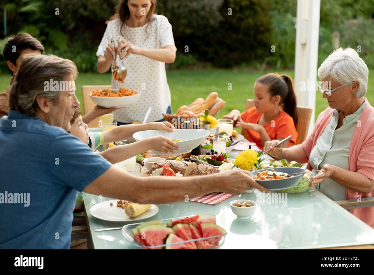 Multi generation family enjoying dinner outside hi-res stock ...