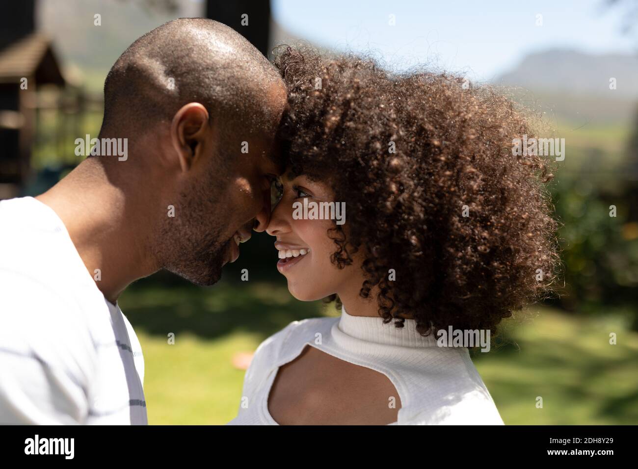 Happy young couple holding each other Stock Photo - Alamy