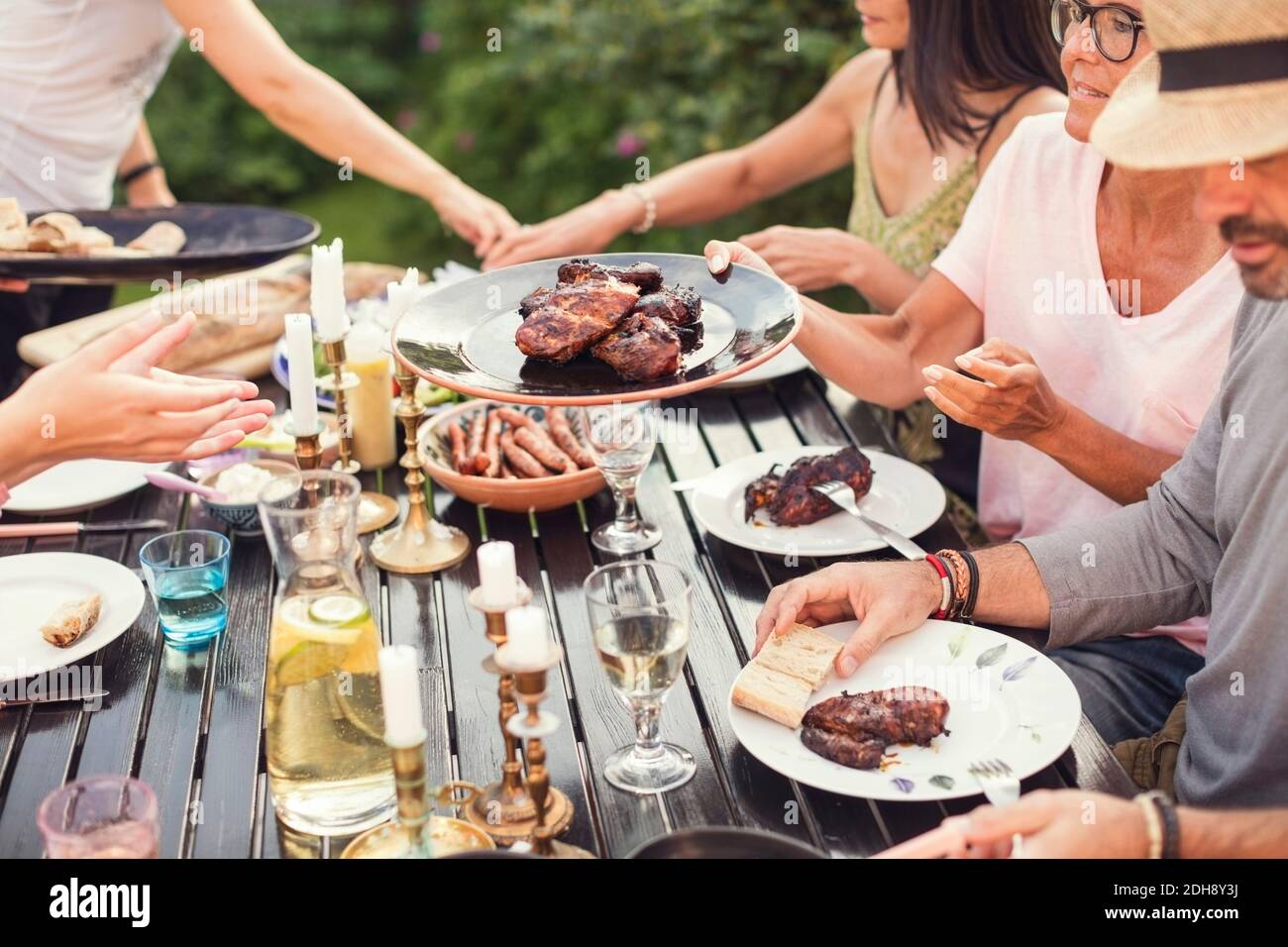 High angle view of people enjoying lunch in garden party at back yard ...