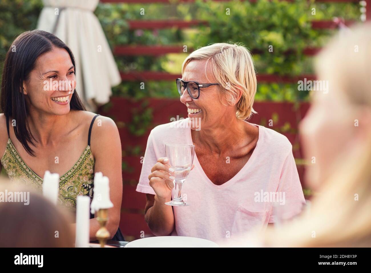 Happy women enjoying garden party in back yard Stock Photo - Alamy