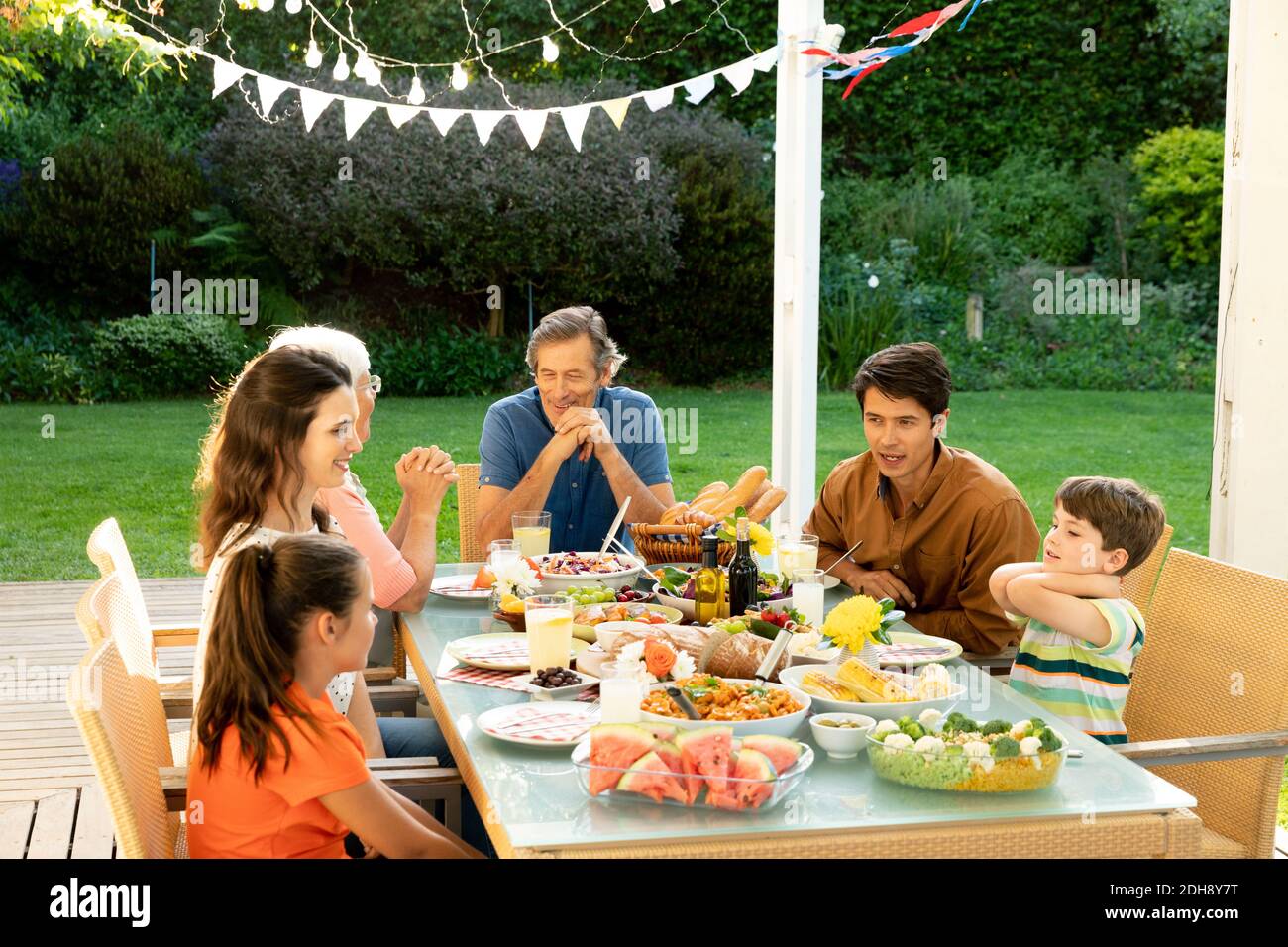 Family eating outside together in summer Stock Photo - Alamy