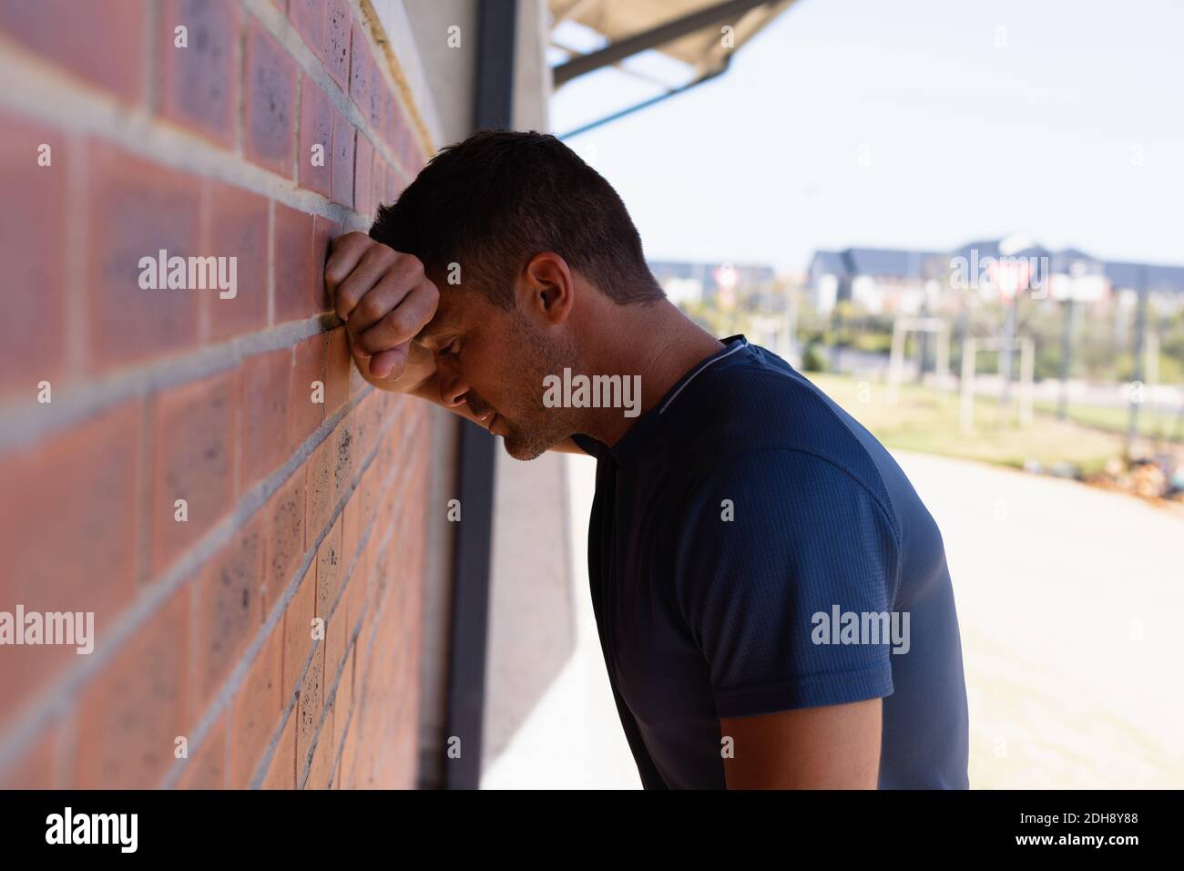 Man leaning on the wall Stock Photo - Alamy