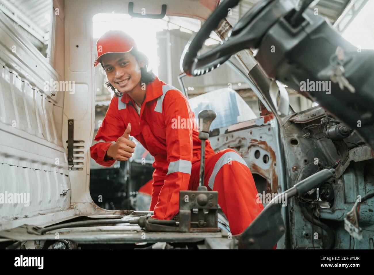 portrait of young asian man repairing a broken car engine part Stock ...