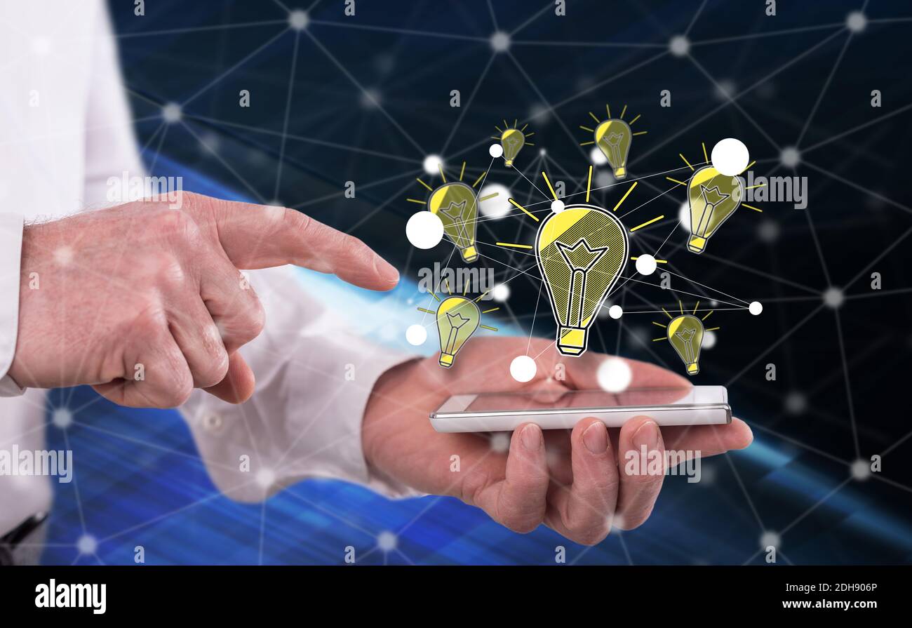Innovation concept above a smartphone held by a man Stock Photo - Alamy
